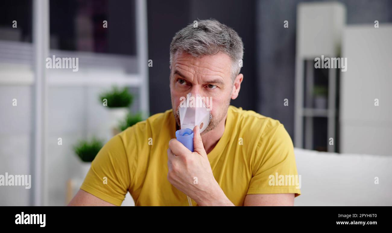 Asthma Patient Breathing Using Oxygen Mask And COPD Nebulizer Stock ...