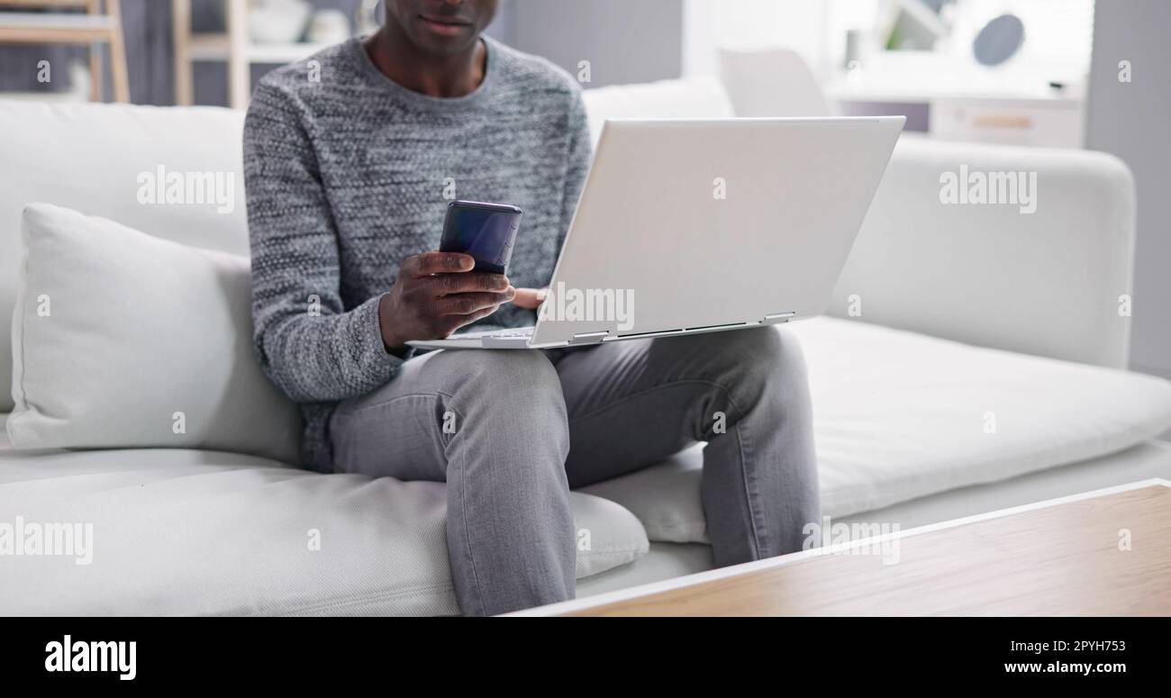 Sitting Home Using Computer Technology Stock Photo - Alamy