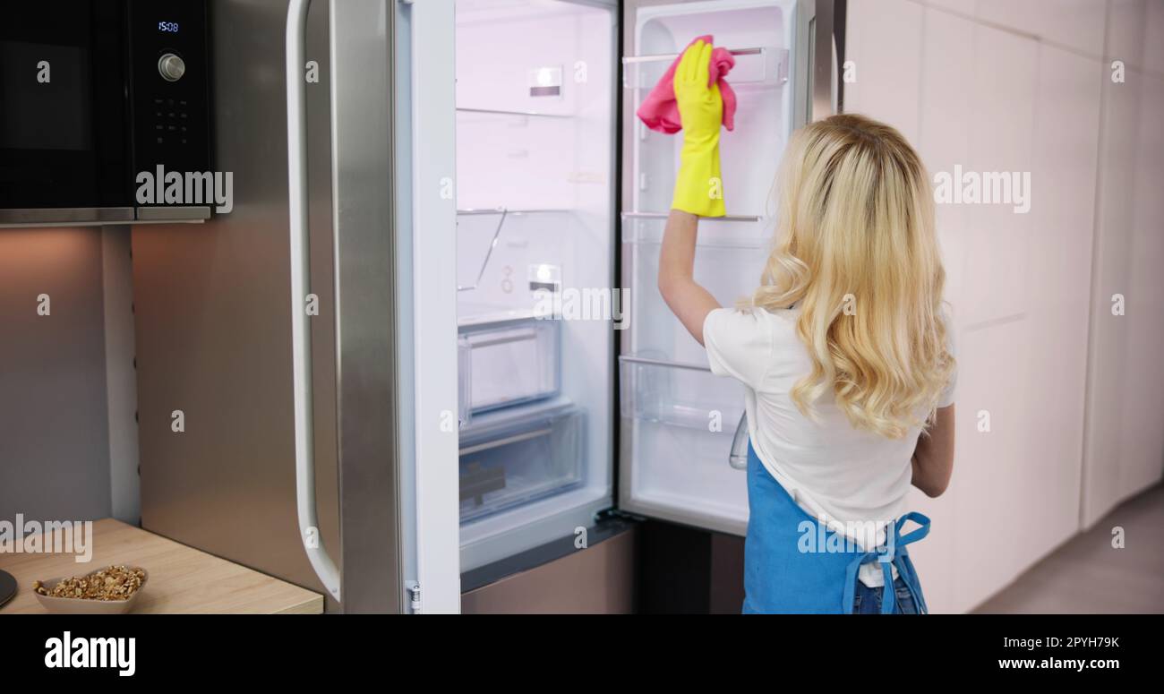 Woman cleaning refrigerator in hi-res stock photography and images - Alamy