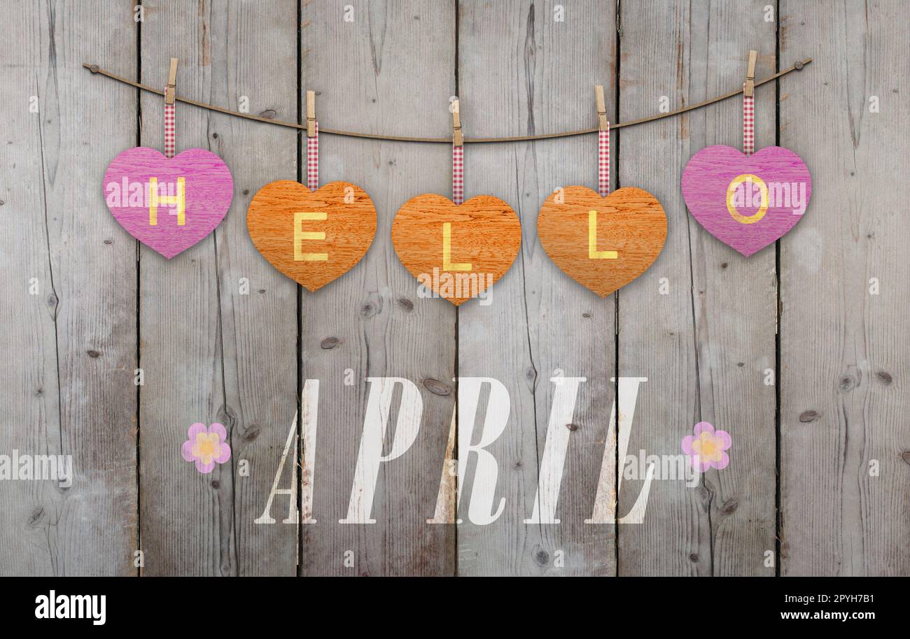 Hello April written on hanging pink and orange hearts and weathered ...