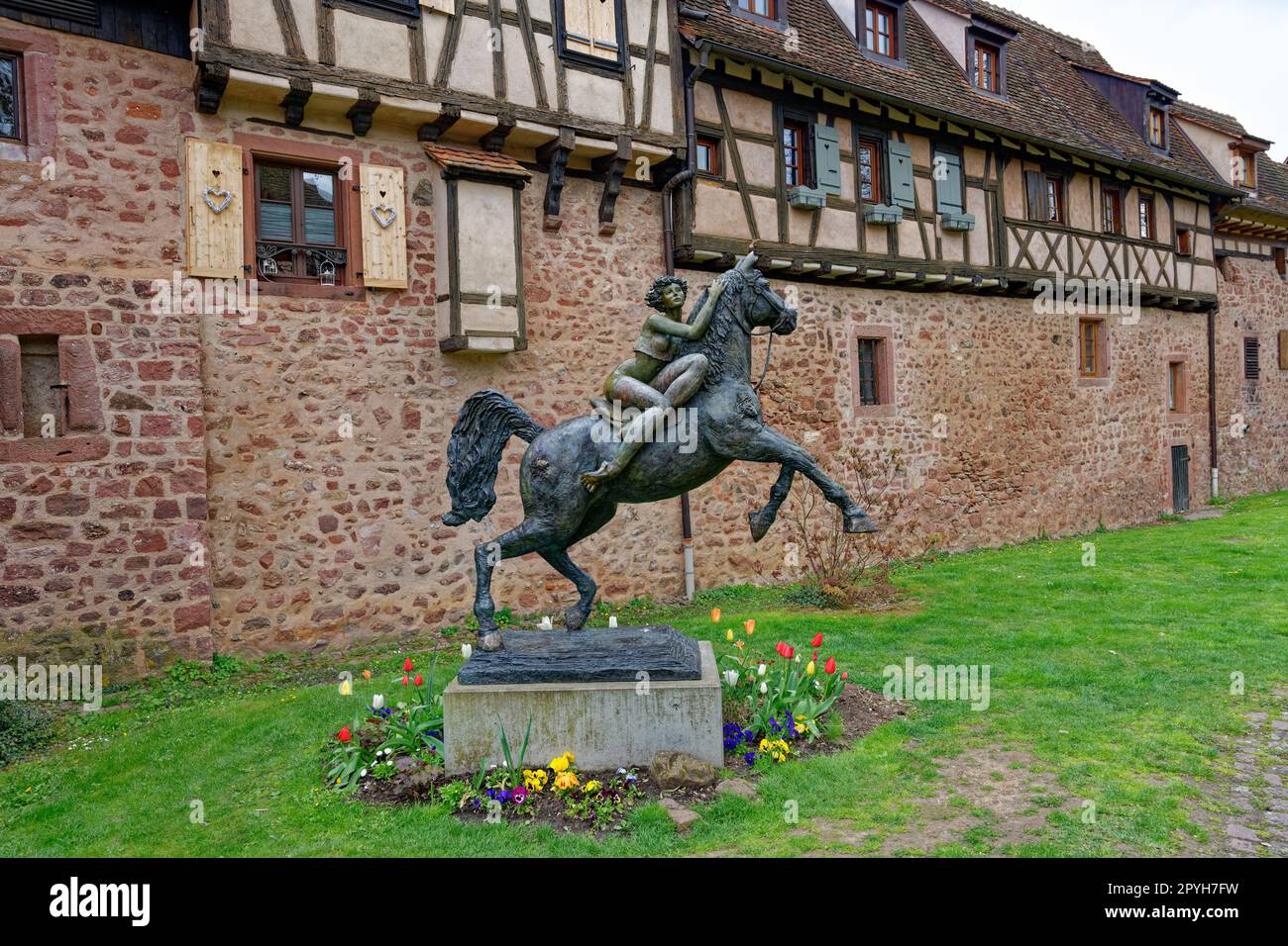 Bronze Statue of Woman RIding a Horse in the village of Riquewihr in ...