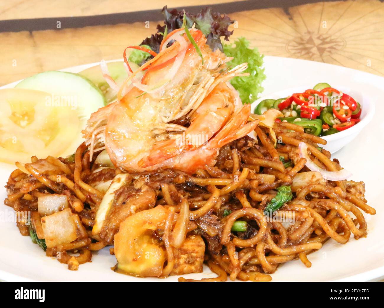 Fried noodles, mee goreng or mi goreng served with prawns. Popular dish ...