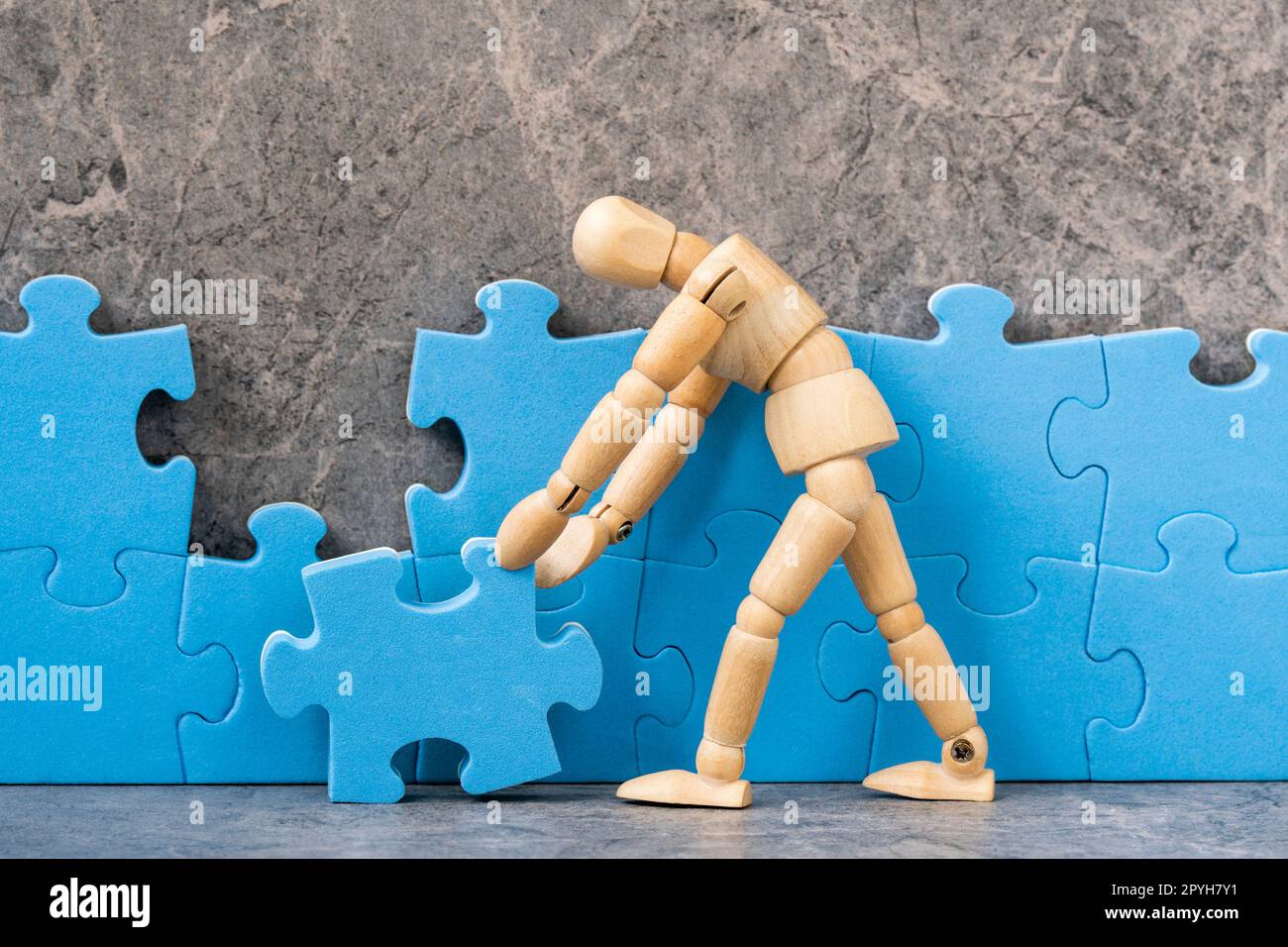 Wooden dummy building blue puzzle. Creating own business concept Stock ...