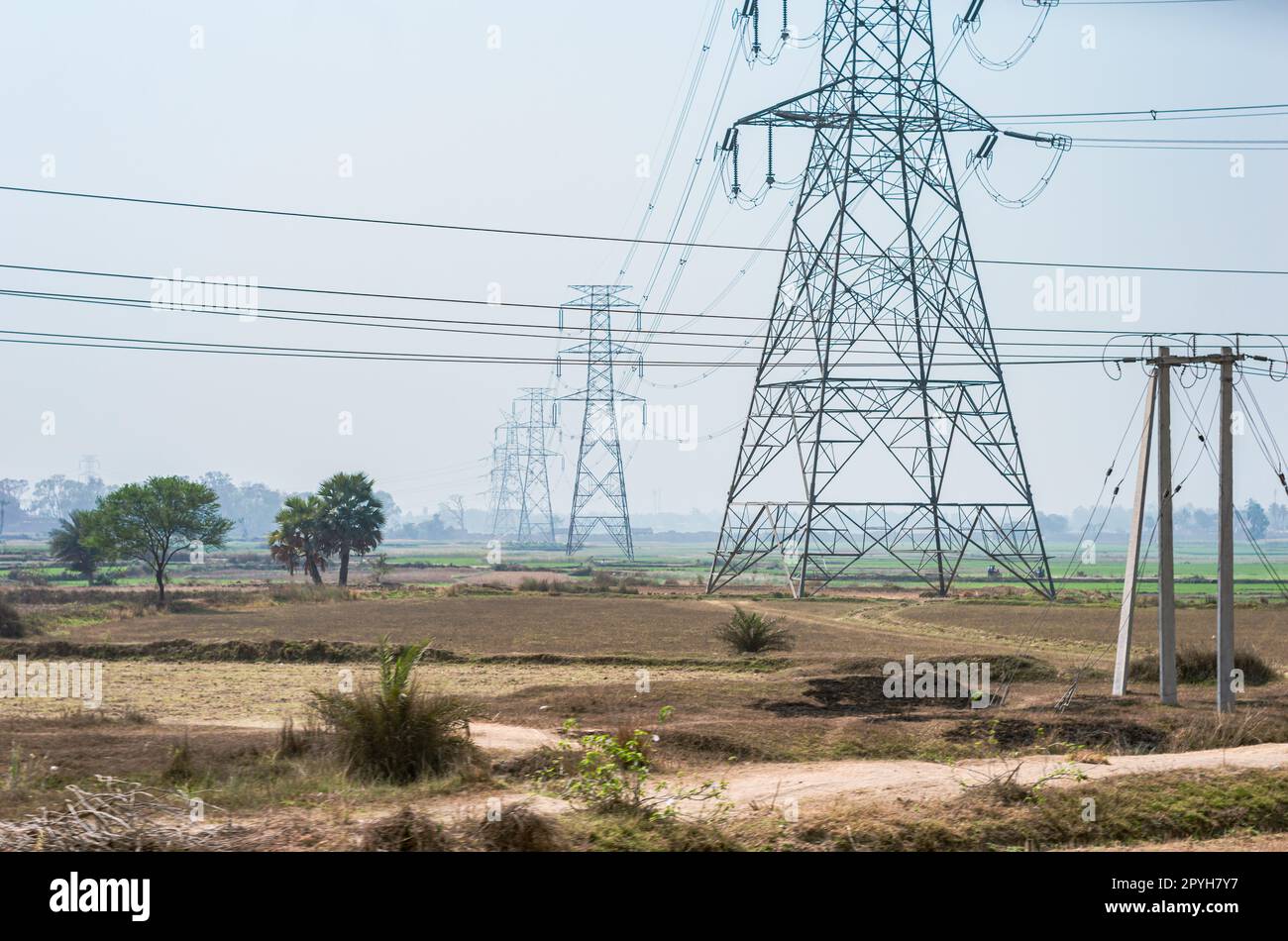 Row of power lines over field hi-res stock photography and images - Alamy