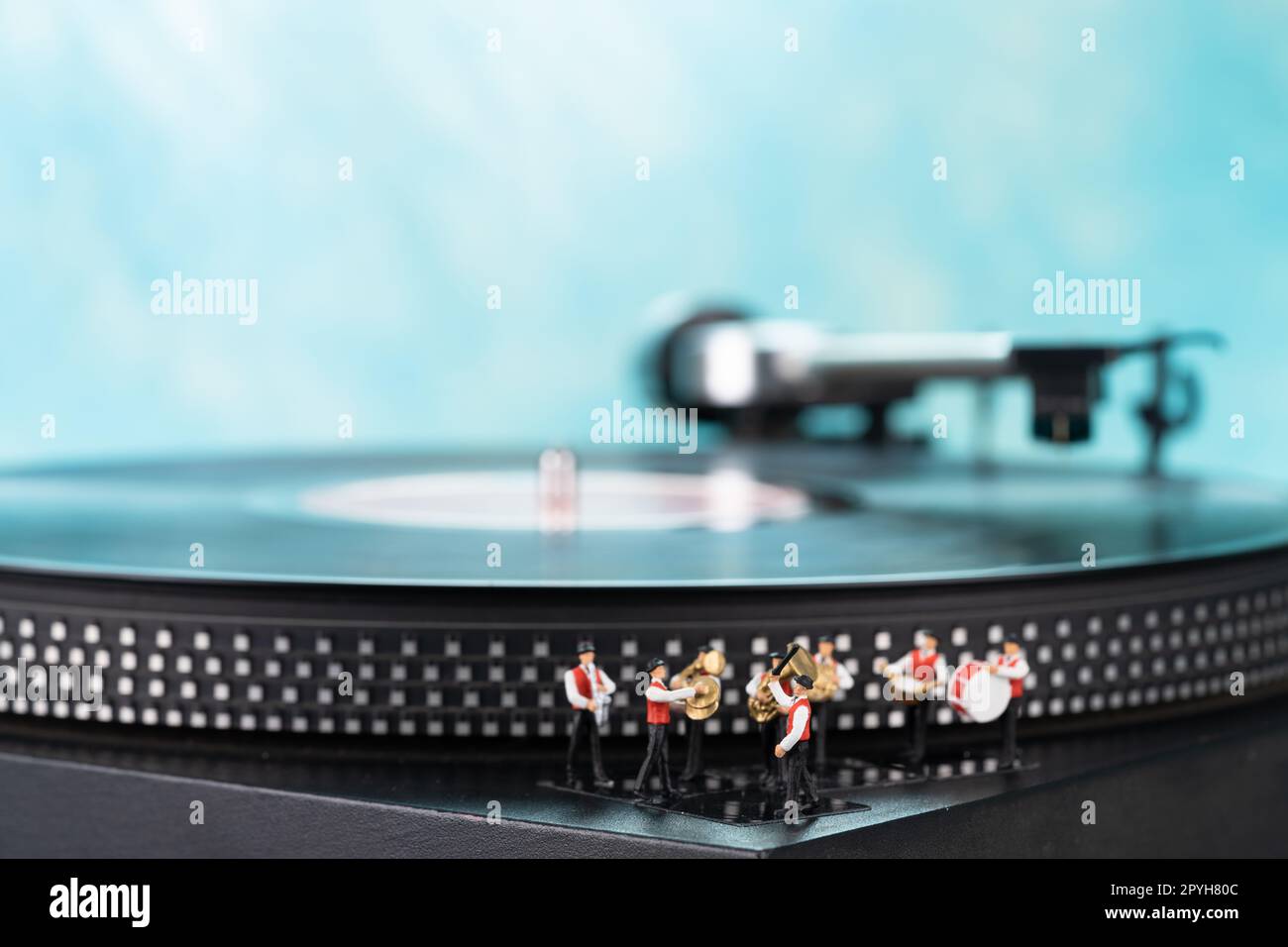 Miniature brass band, turntable and blue background Stock Photo - Alamy