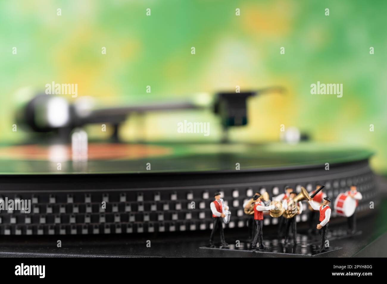 Miniature brass band, turntable and yellow green background Stock Photo ...