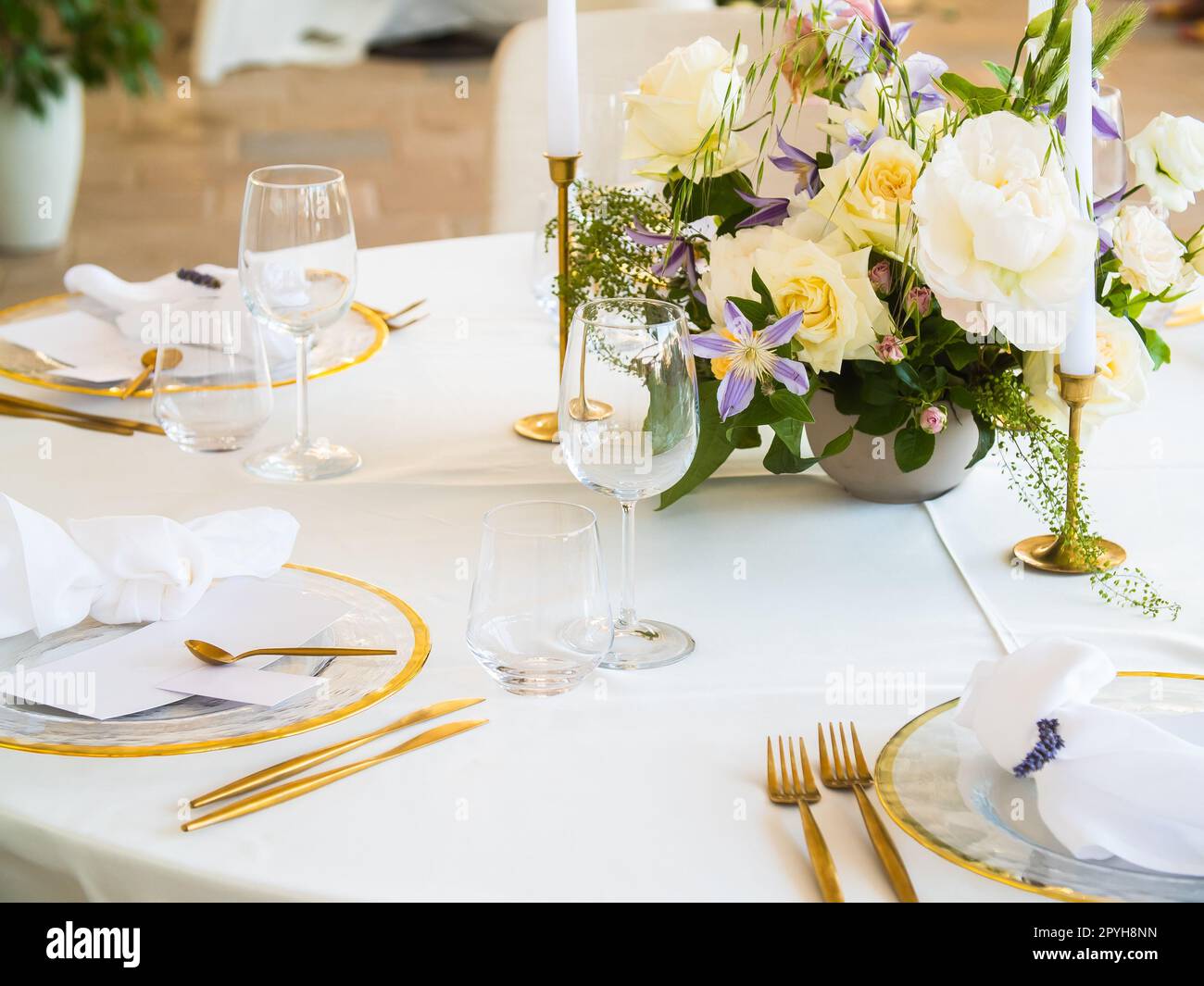 Wedding banquet concept. Chairs and round table for guests, served with ...