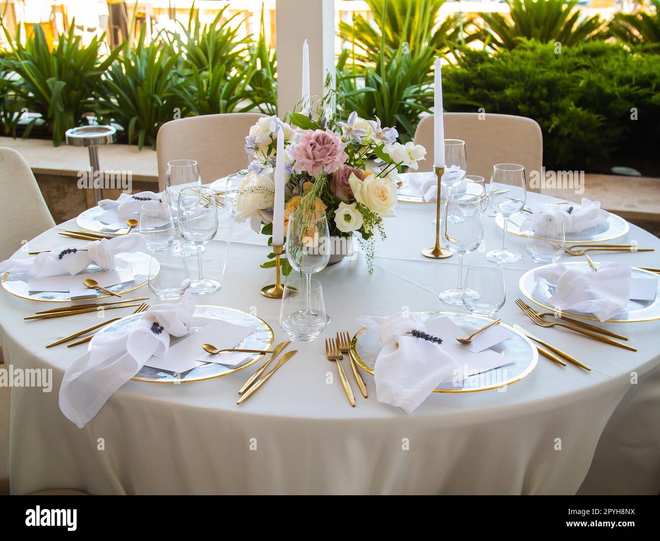 Wedding banquet concept. Chairs and round table for guests, served with ...