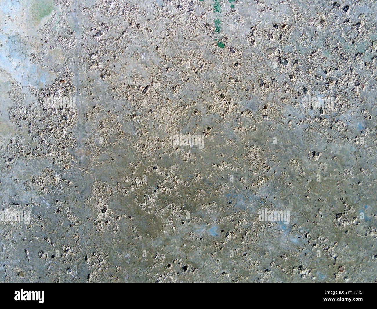 Concrete wall with concentric damage of large radius. Potholes ...