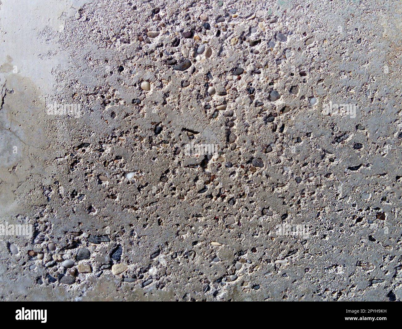 Concrete wall with concentric damage of large radius. Potholes ...