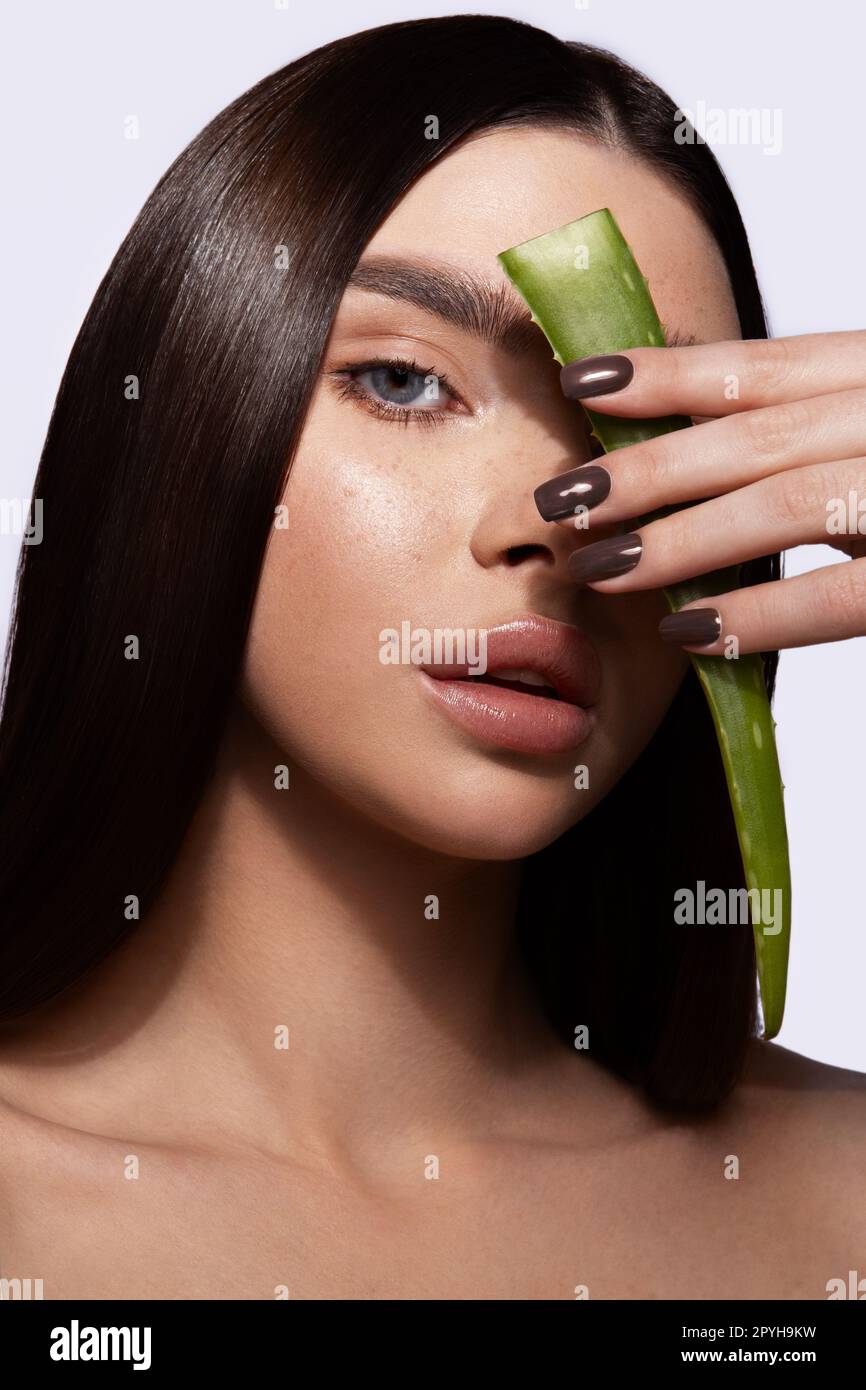 Beautiful young woman with aloe vera on white background Stock Photo ...