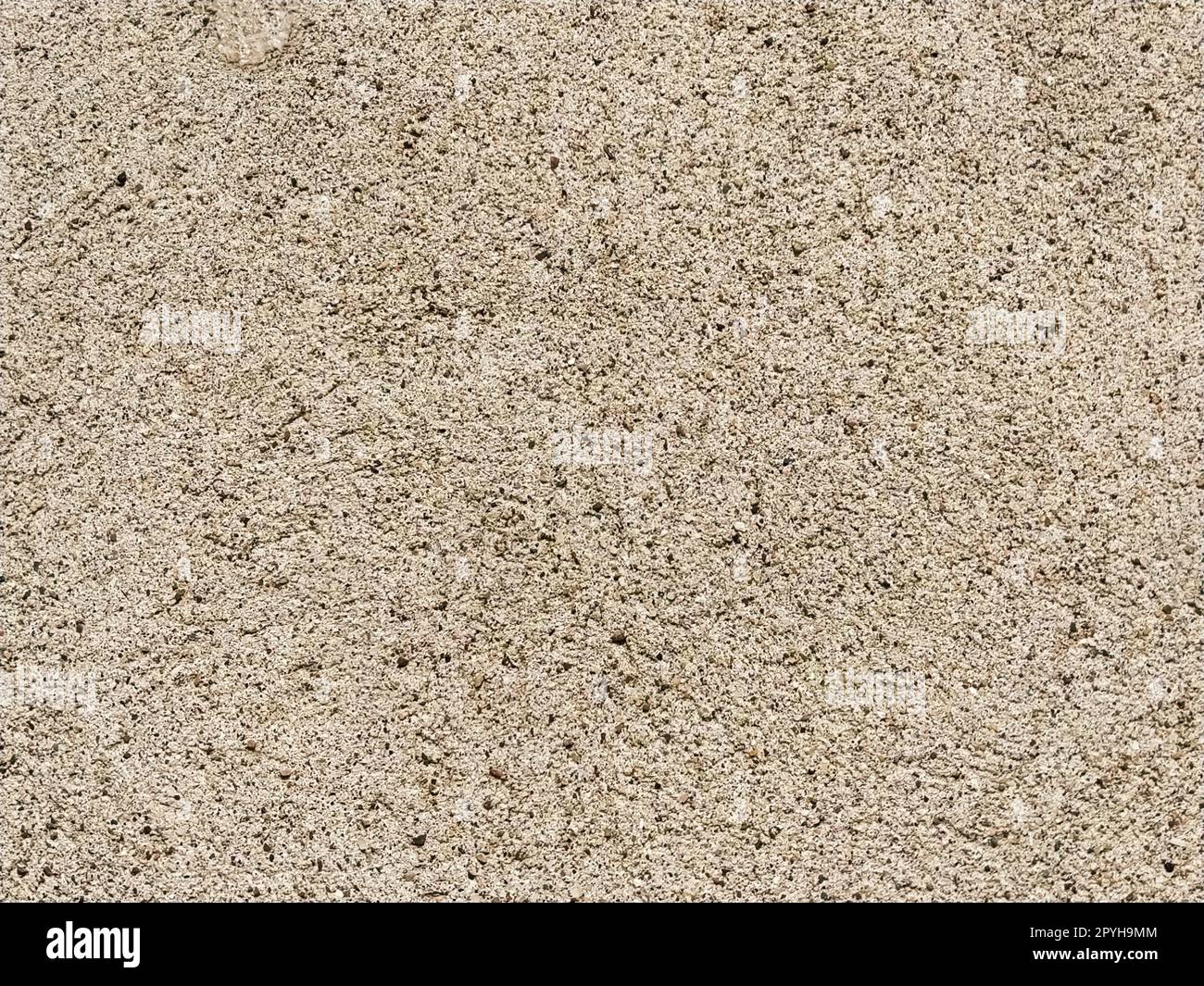 Concrete surface with multi-colored blotches of small stones. Light ...