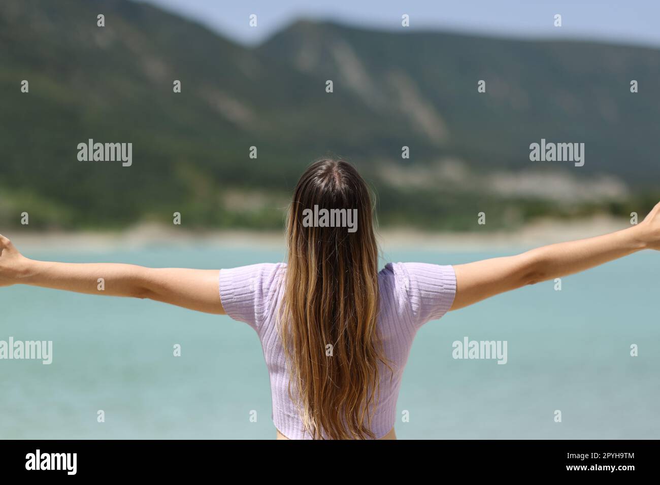 Back view of a woman outstretching arms in nature Stock Photo - Alamy