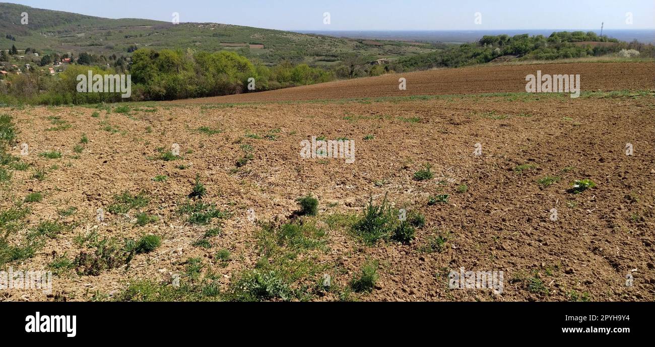The slopes of the mountains with agricultural fields. Freshly plowed ...
