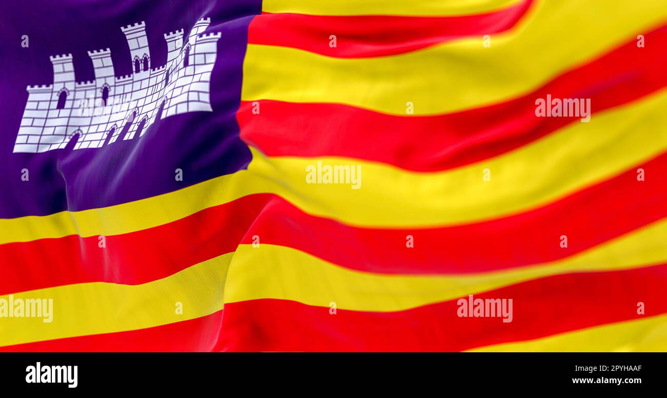 Detail of the Balearic Islands flag waving in the wind. Four red lines ...