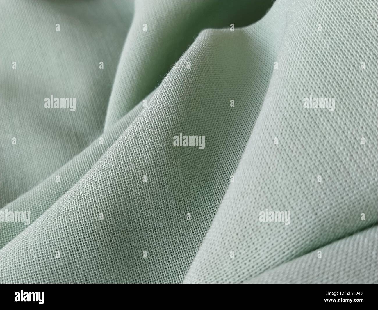 Close up of a woolen fabric of green color. Abstract canvas background ...