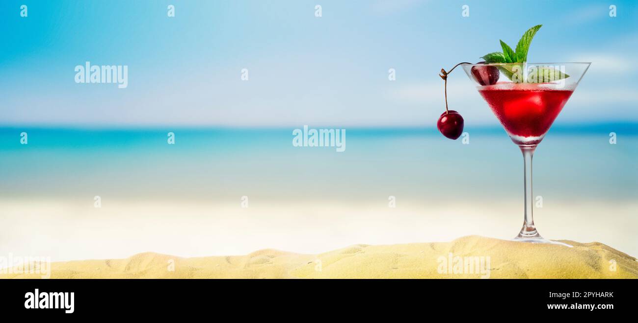 Cherry cocktail in martini glass on tropical sandy beach Stock Photo ...