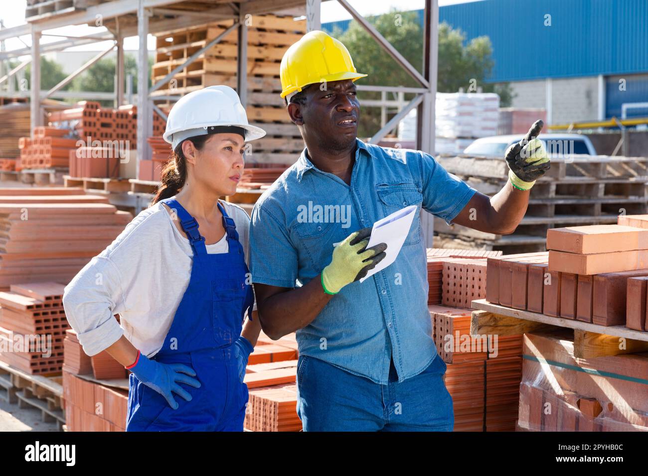 Male manager giving instructions to a female worker Stock Photo - Alamy