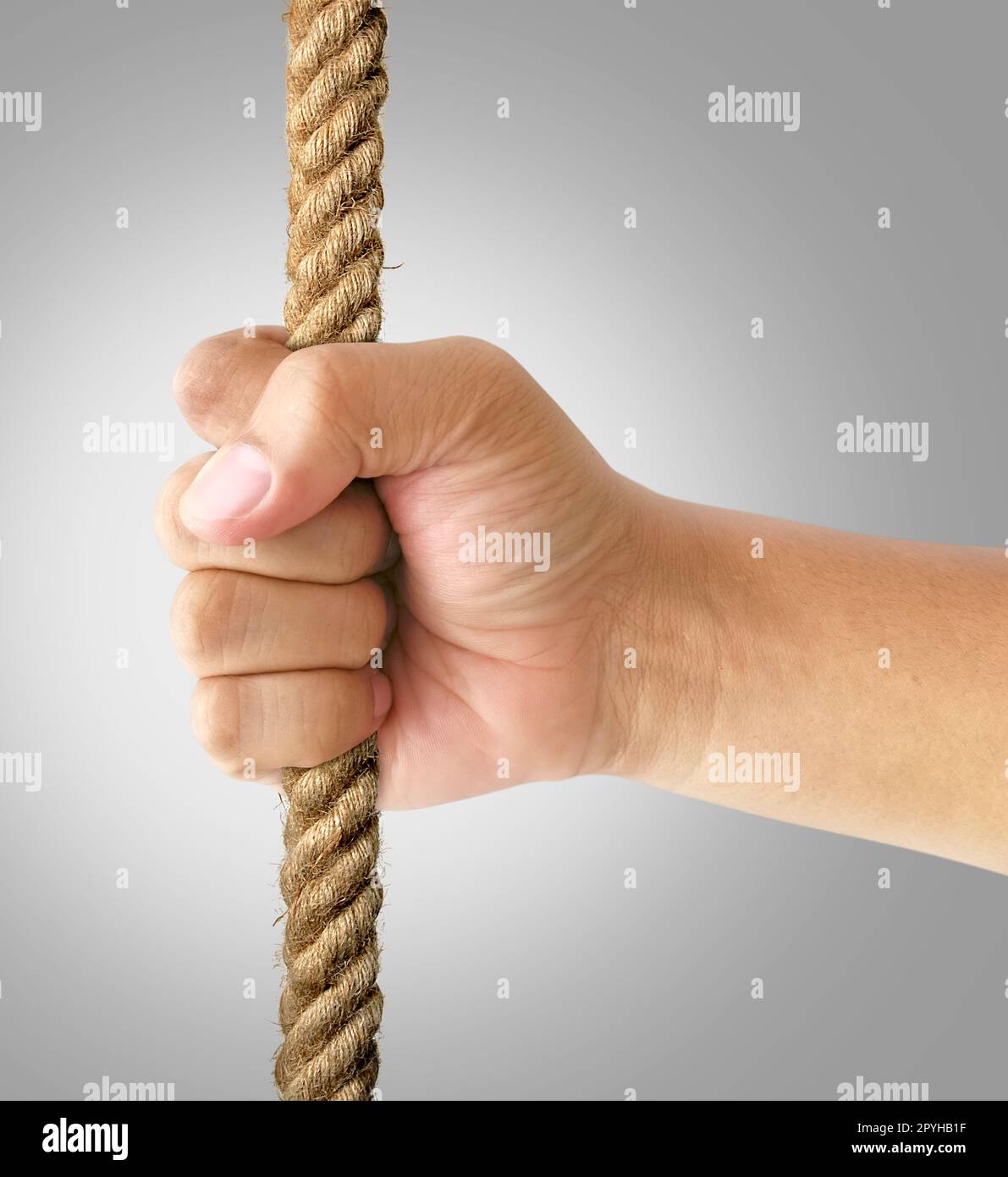 Hand holding tight onto rope. Hanging on, strength and determination, people in need of help ...