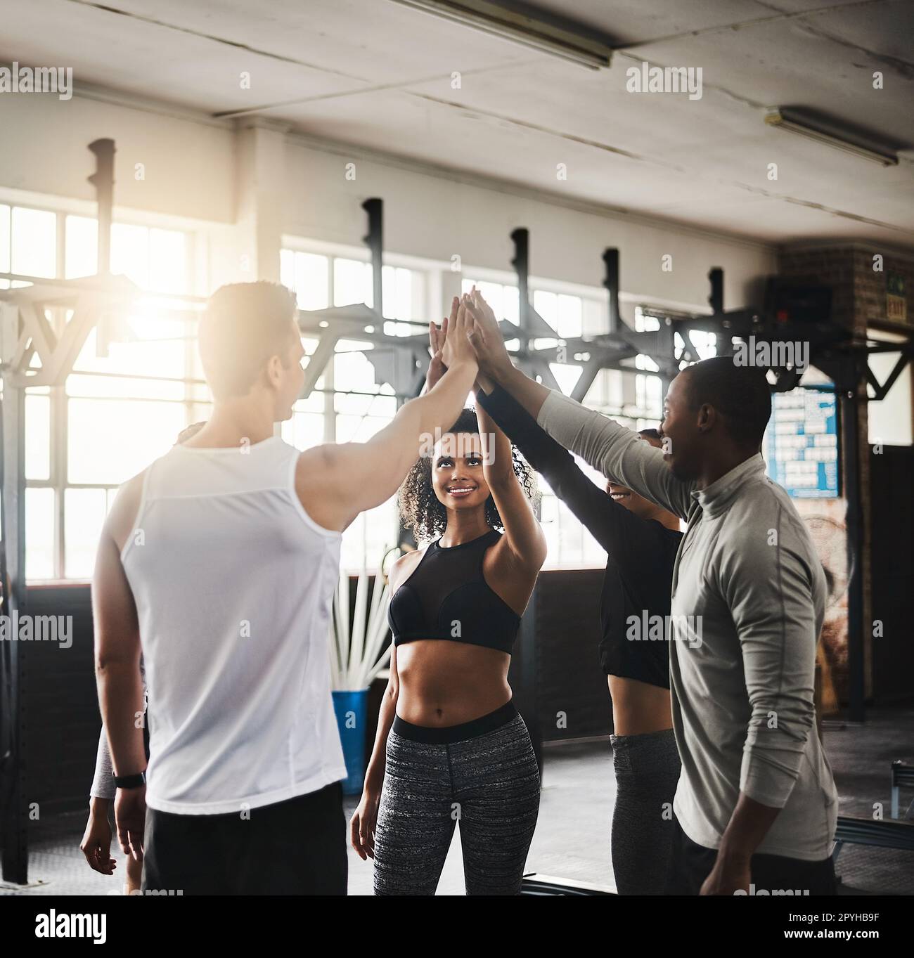 Teamwork makes the fitness dream work. a group of young people giving ...