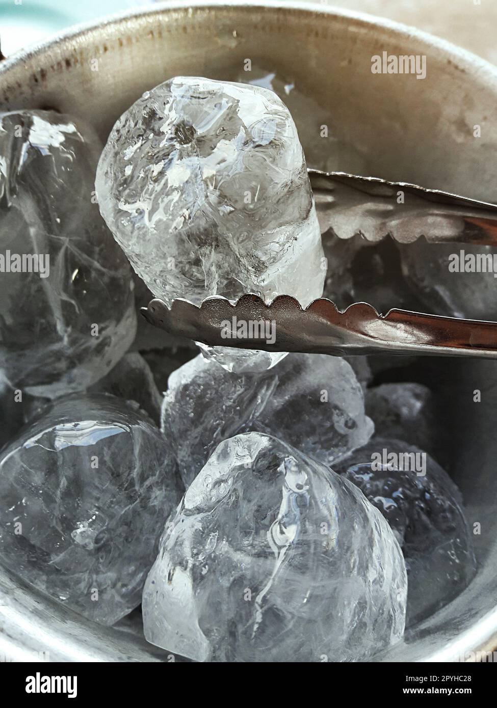 Ice bucket with hand holding tongs Stock Photo - Alamy