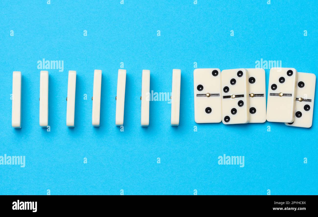 A stack of dominoes on a blue background, an intellectual game Stock ...