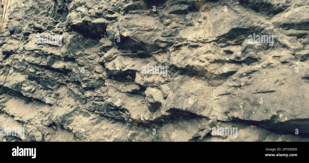 Stone rock close up. Ancient frozen lava. Layers and strata of rocks ...