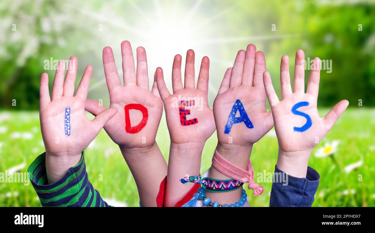 Children Hands Building Word Ideas, Grass Meadow Stock Photo - Alamy