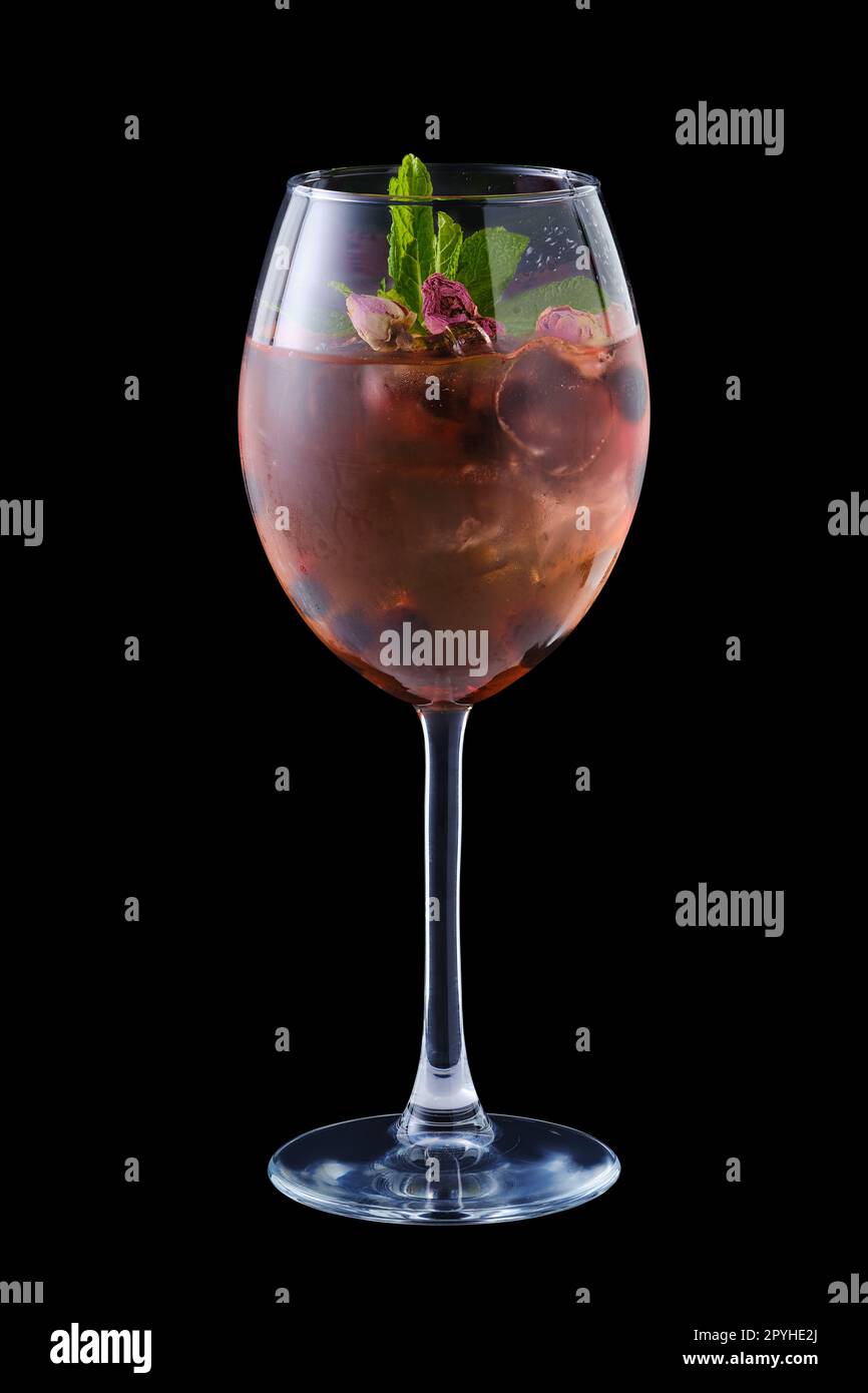 Cold red sangria with dry rosebuds in a wine glass on black background ...