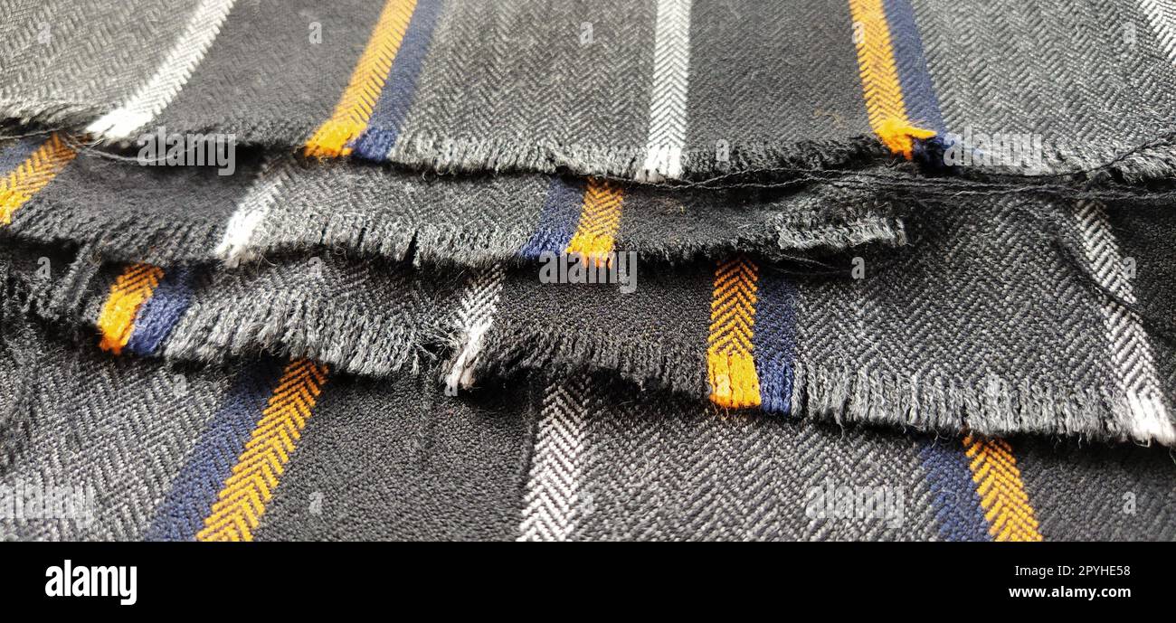 Light black-gray folded fabric with orange and dark blue stripes ...