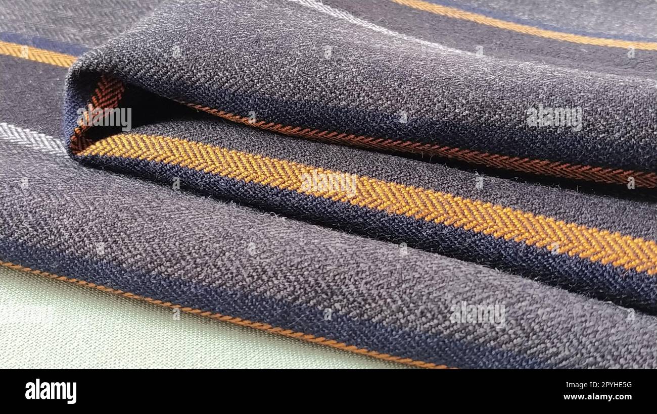 Gray-black fabric with orange and blue stripes. Textile fabric folded ...