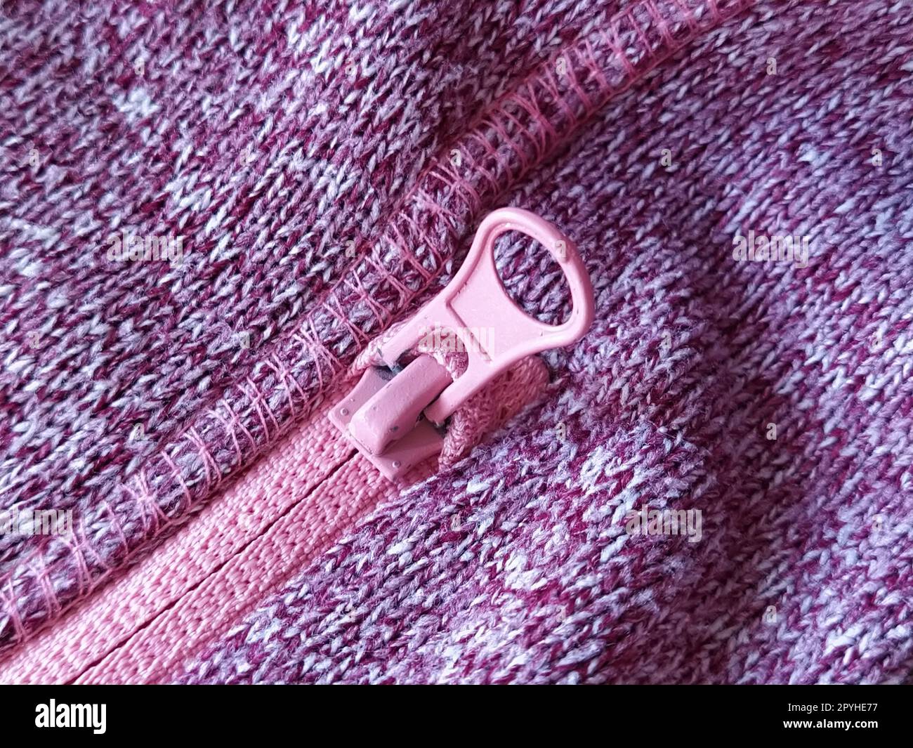 pink lock with a slider on the knitted fabric Stock Photo - Alamy