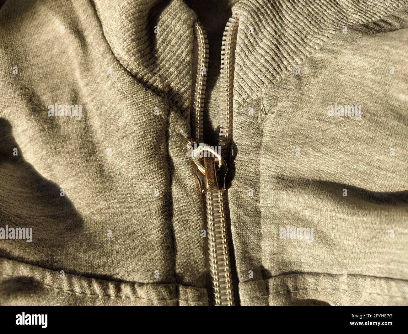 metal lock on gray long sleeve fabric. Tailoring Stock Photo - Alamy