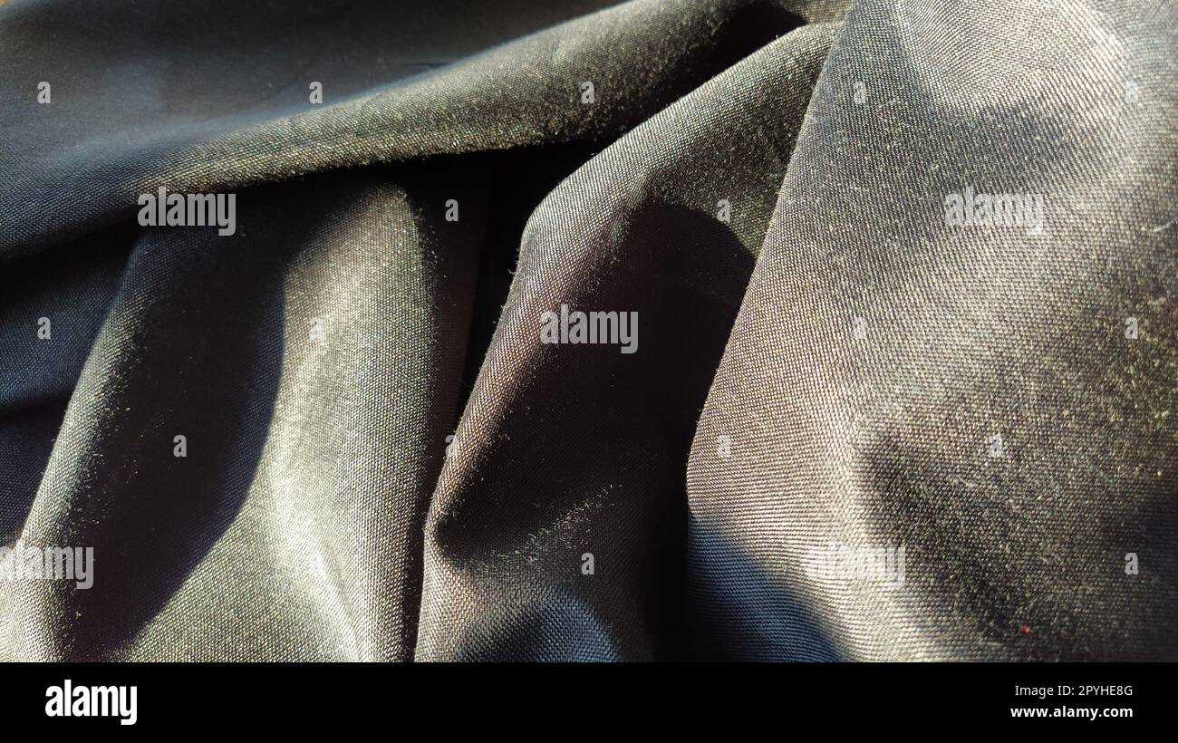 black fabric with interlacing threads close-up. Dark blue tint. Nice ...
