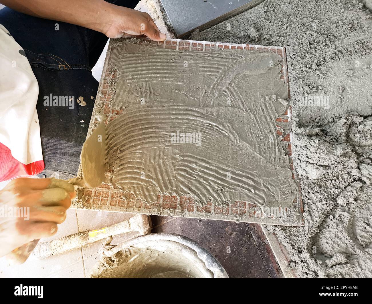 Close-up Installing tiles floor in construction work Stock Photo - Alamy