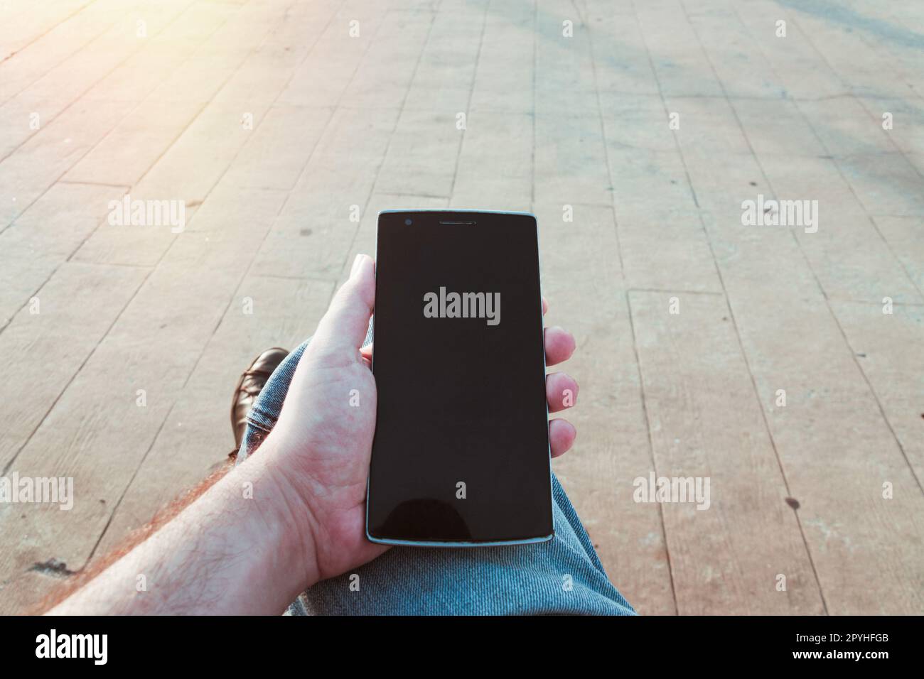 Man using the smartphone outdoors Stock Photo - Alamy