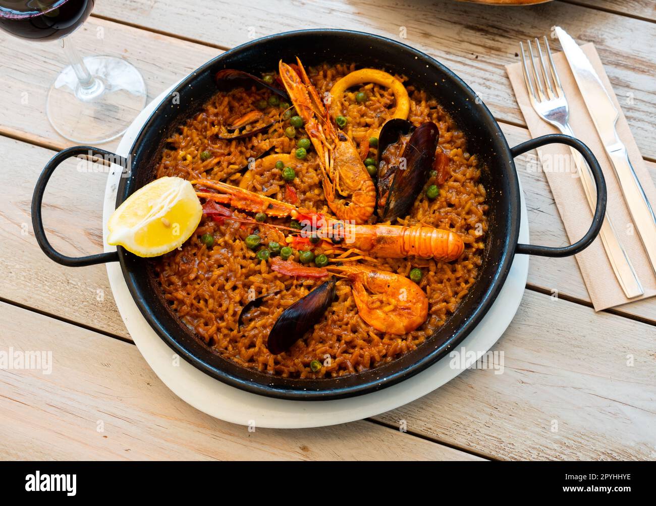 Racy seafood paella with mussels, calamari and prawns Stock Photo - Alamy