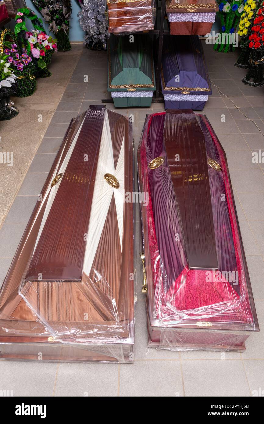 Interior of room with funeral accessories. Shop selling coffins ...