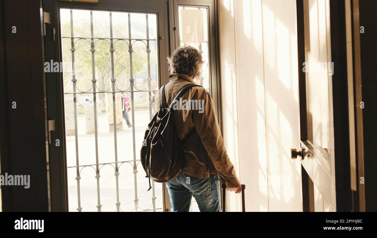 Middle aged man leaving home with luggage Stock Photo - Alamy