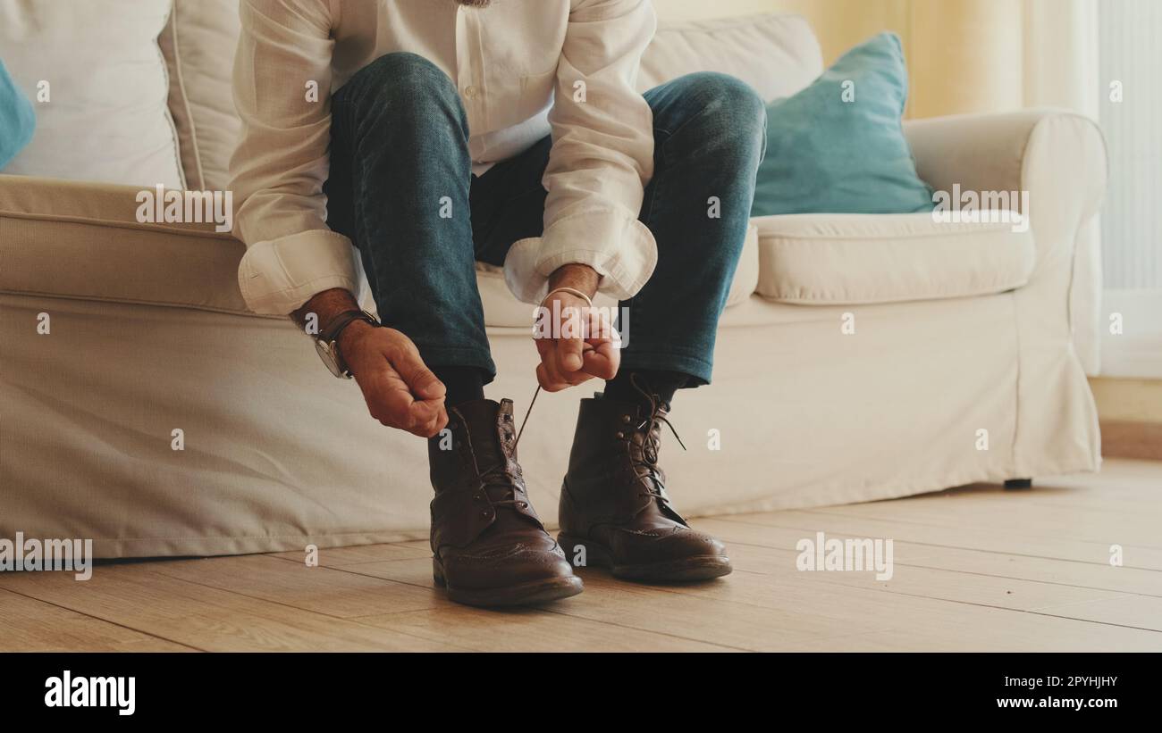 Business man tying shoelaces on hi-res stock photography and images - Alamy