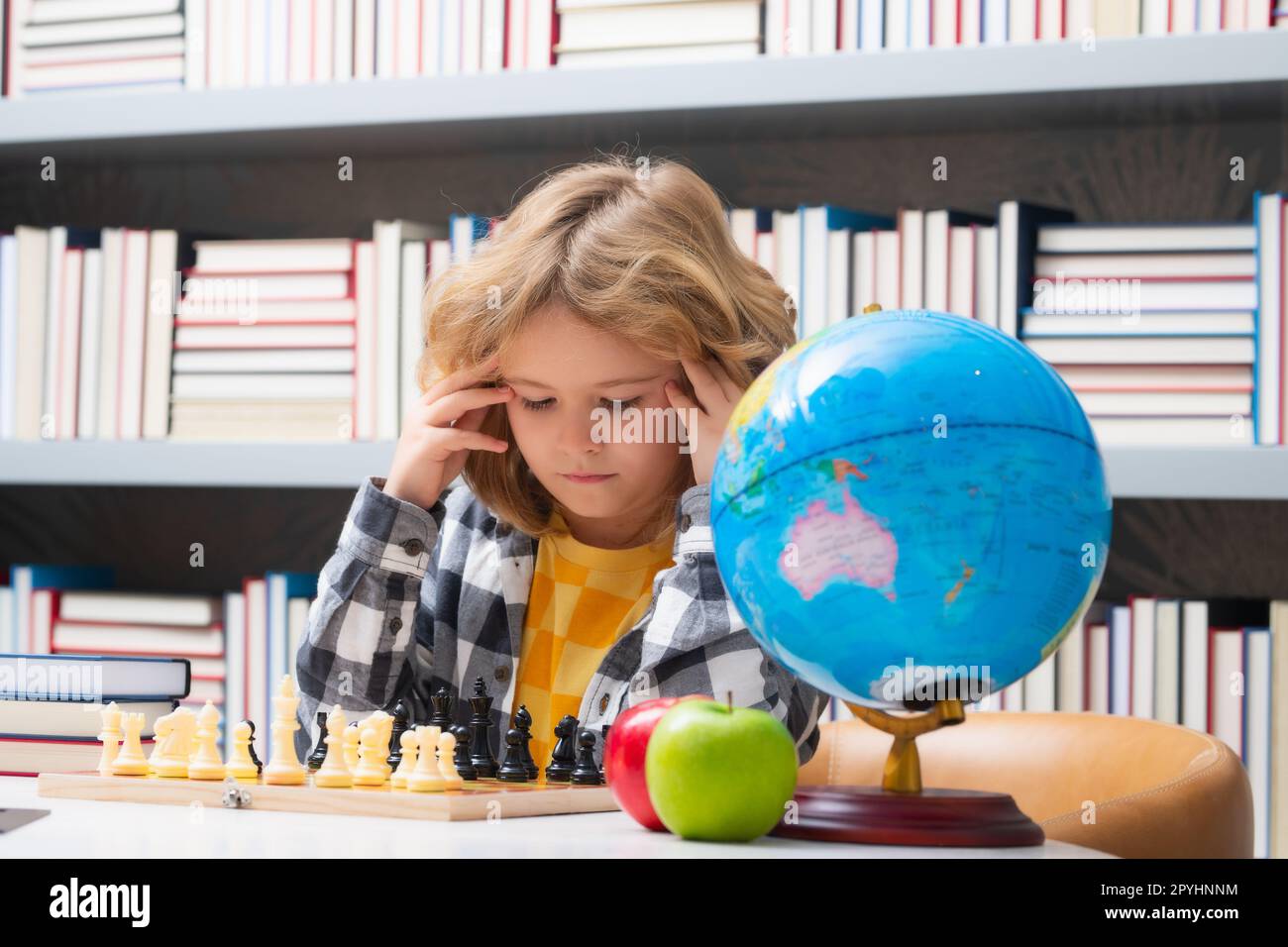 Clever concentrated and thinking kid playing chess. Kids brain ...