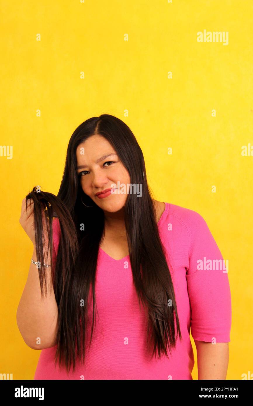 Latin Adult Woman With Very Long Straight Hair Suffers And Is Sad Because Her Hair Is A Mess And