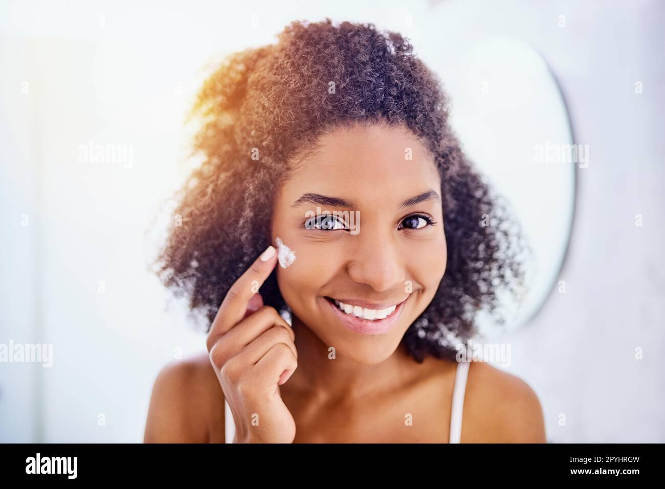 Instant hydration for my skin. an attractive young woman applying ...