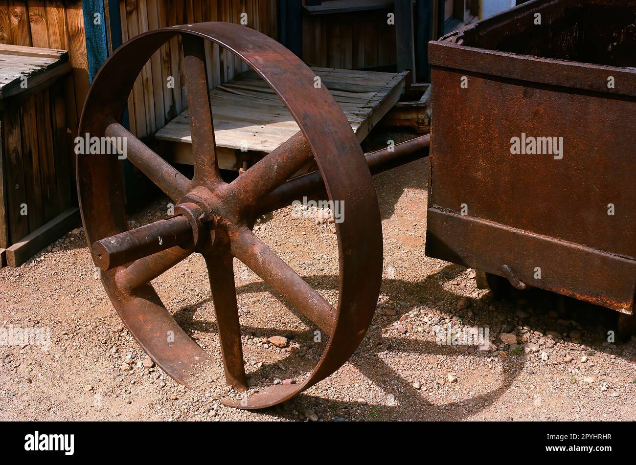 Antigue rusted Iron Wagon Wheel on iron axle Stock Photo - Alamy