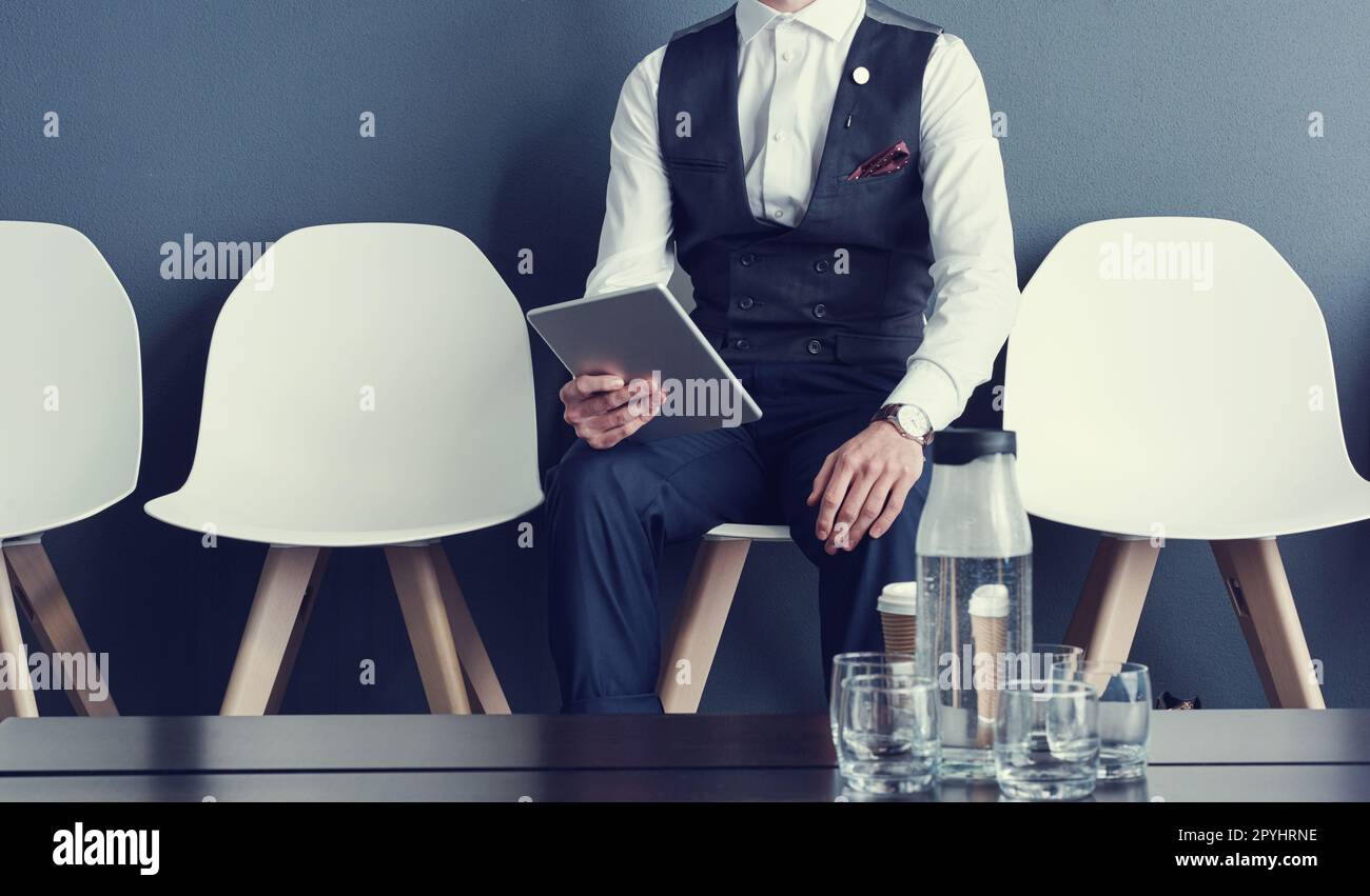 Waiting with wifi. an unrecognizable businessman using a tablet while ...
