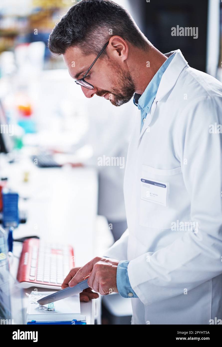Calculating the correct dosage. a mature pharmacist sorting medication ...