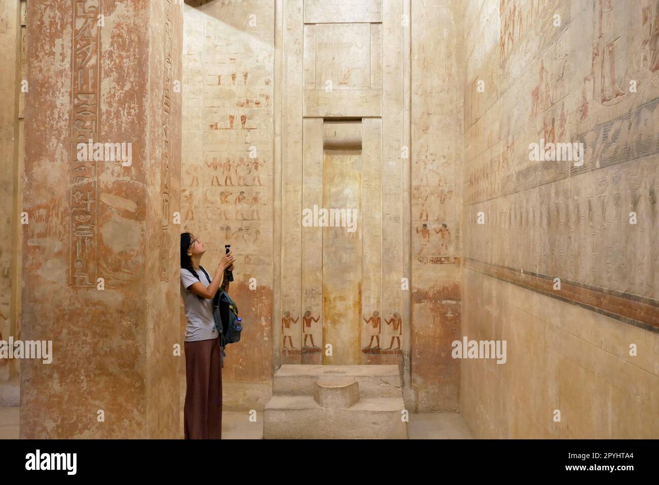 Female Chinese tourist exploring an ancient tomb in Saqqara Stock Photo ...
