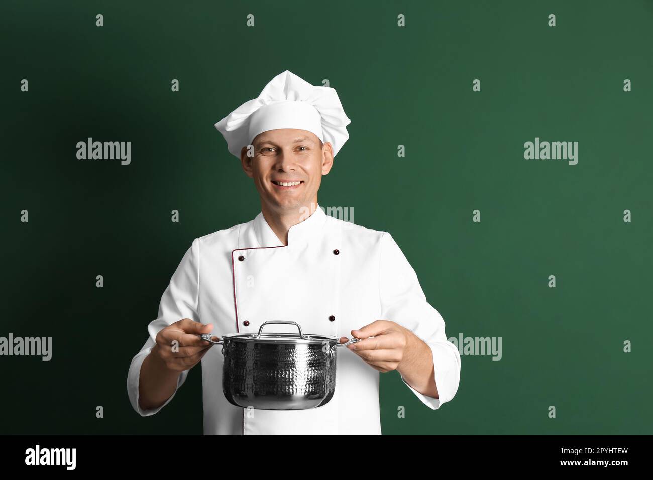 Happy male chef with cooking pot on dark green background Stock Photo ...