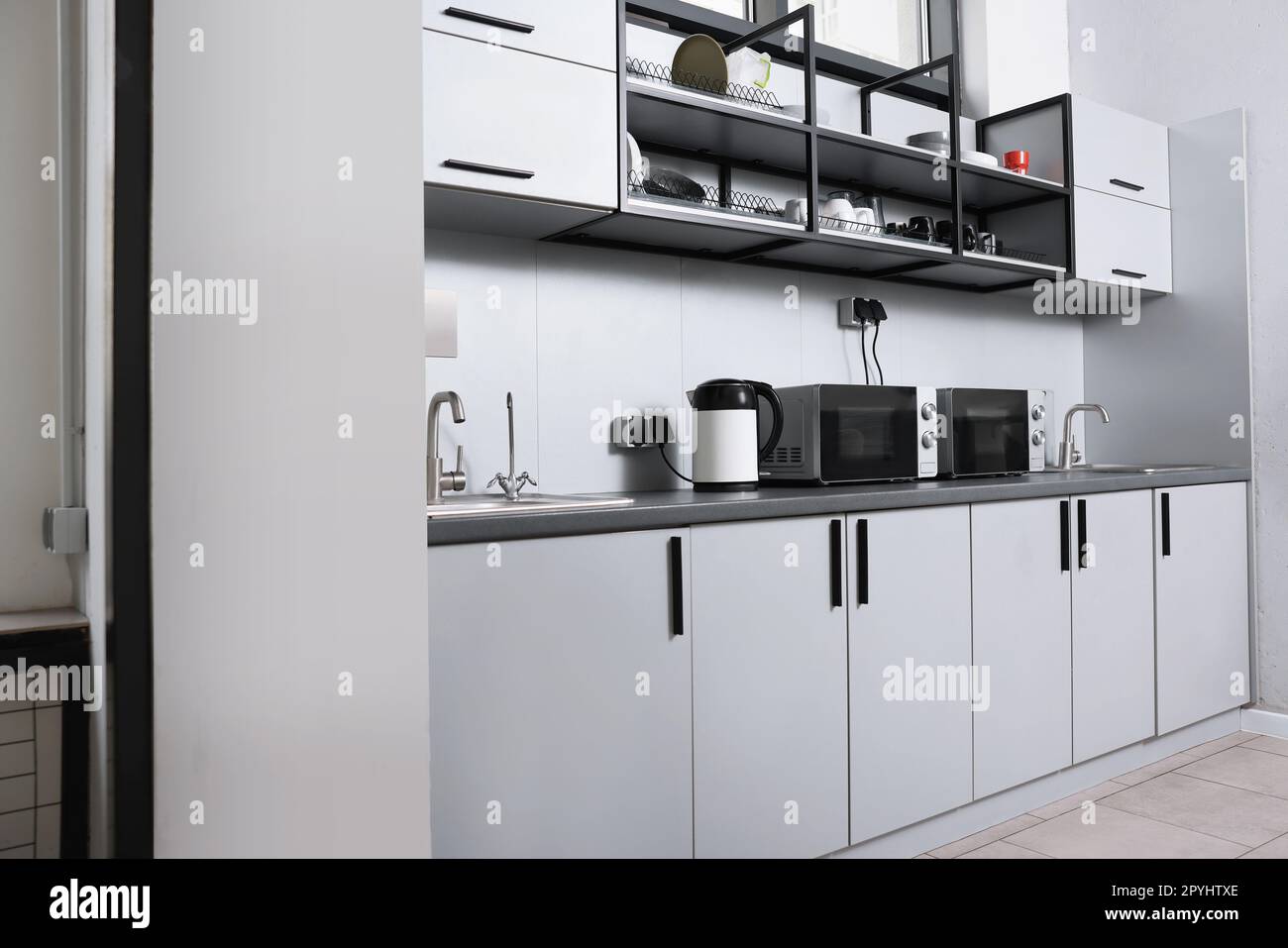 Hostel kitchen interior with modern furniture and appliances Stock ...