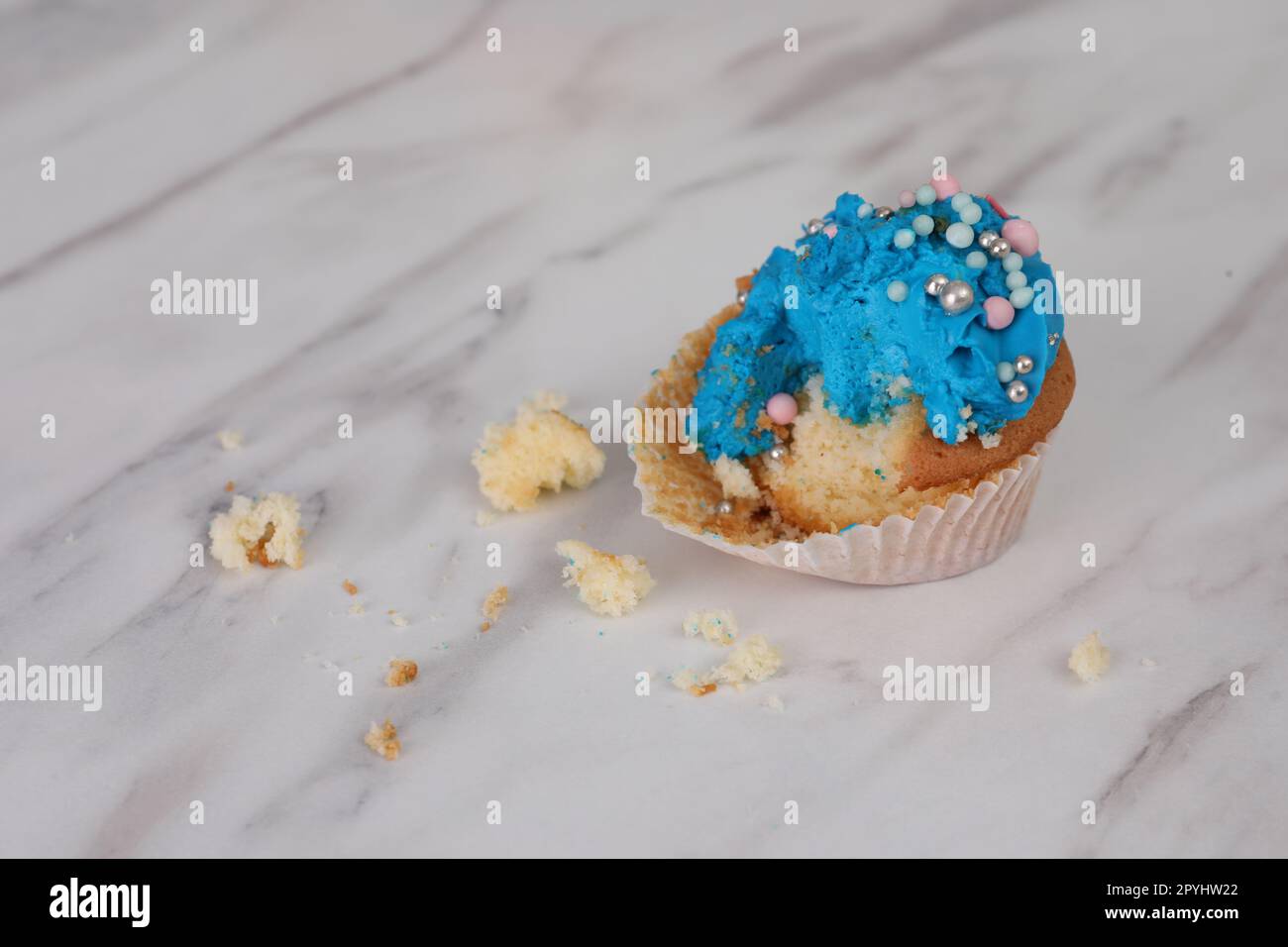 Failed cupcake with cream on light table. Troubles happen Stock Photo ...